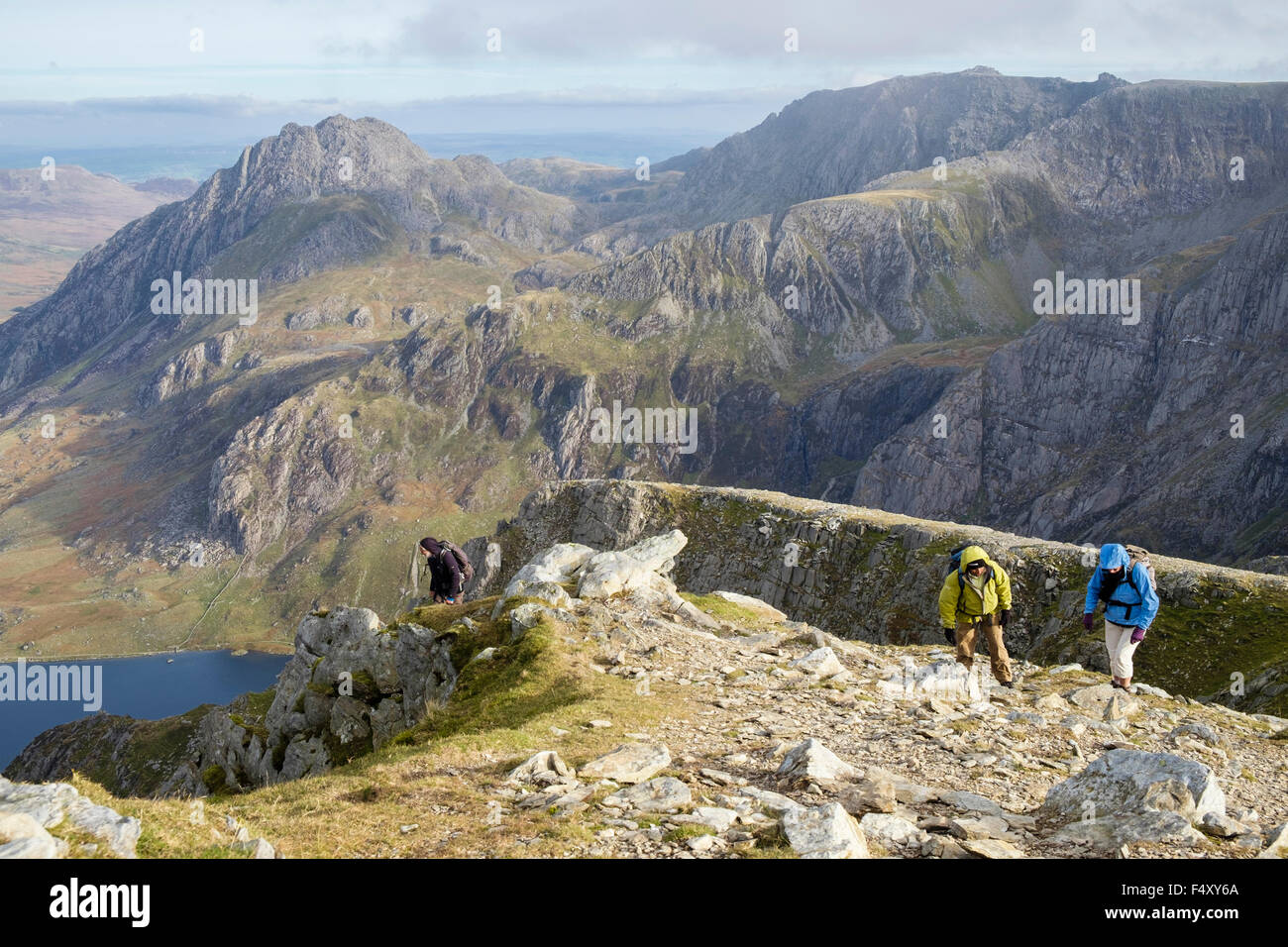 Hikers climbing up Y Garn with view to Mount Tryfan and Glyderau in ...
