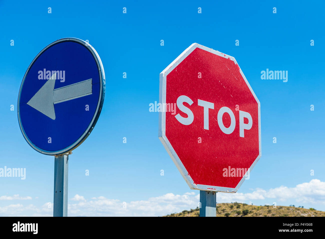 Stop sign and signal direction compulsory against the sky in Spain ...