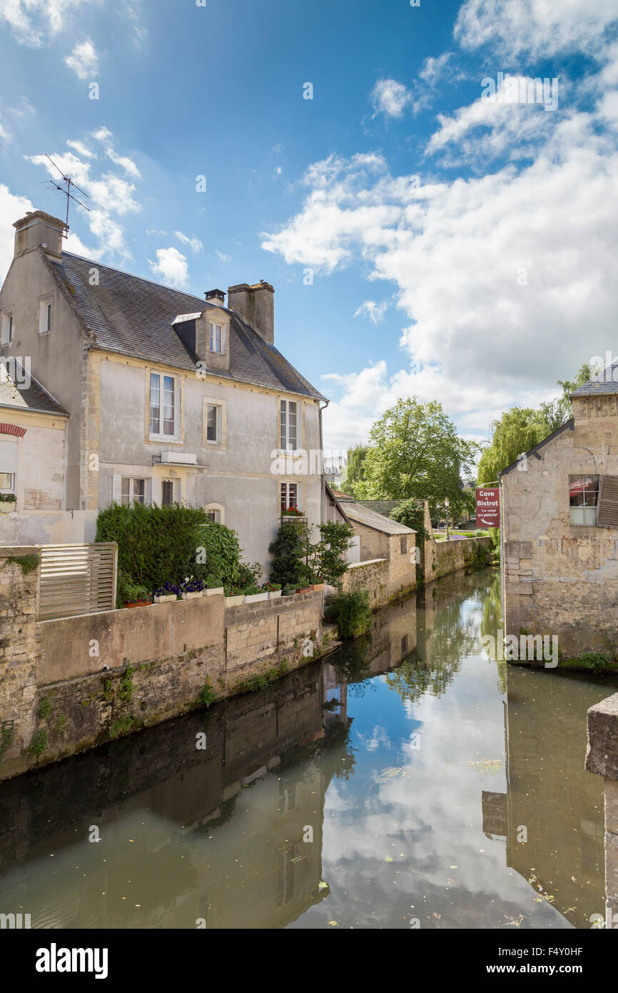 Historic buildings along the The Aure River flowing through Bayeux town ...