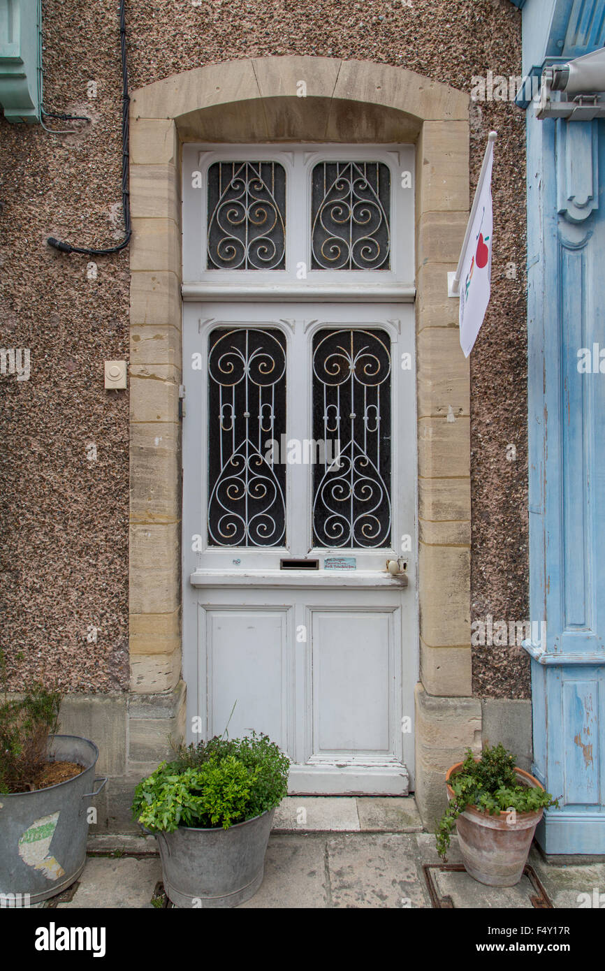 Historic ornate ironwork and wooden entrance door on a Bayeux street ...