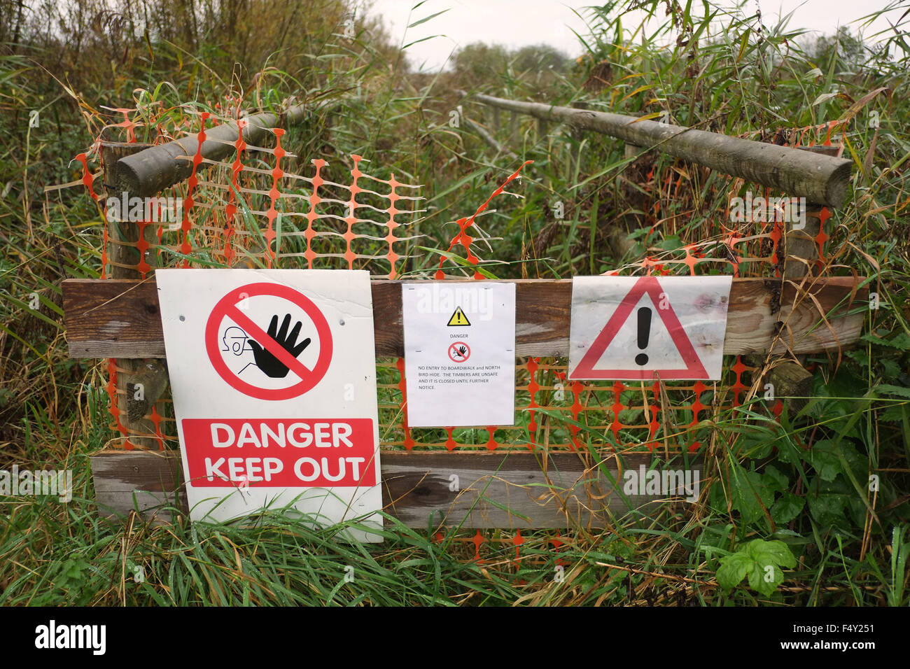 Danger and keep out warning signs on the walkway to a hide on the ...