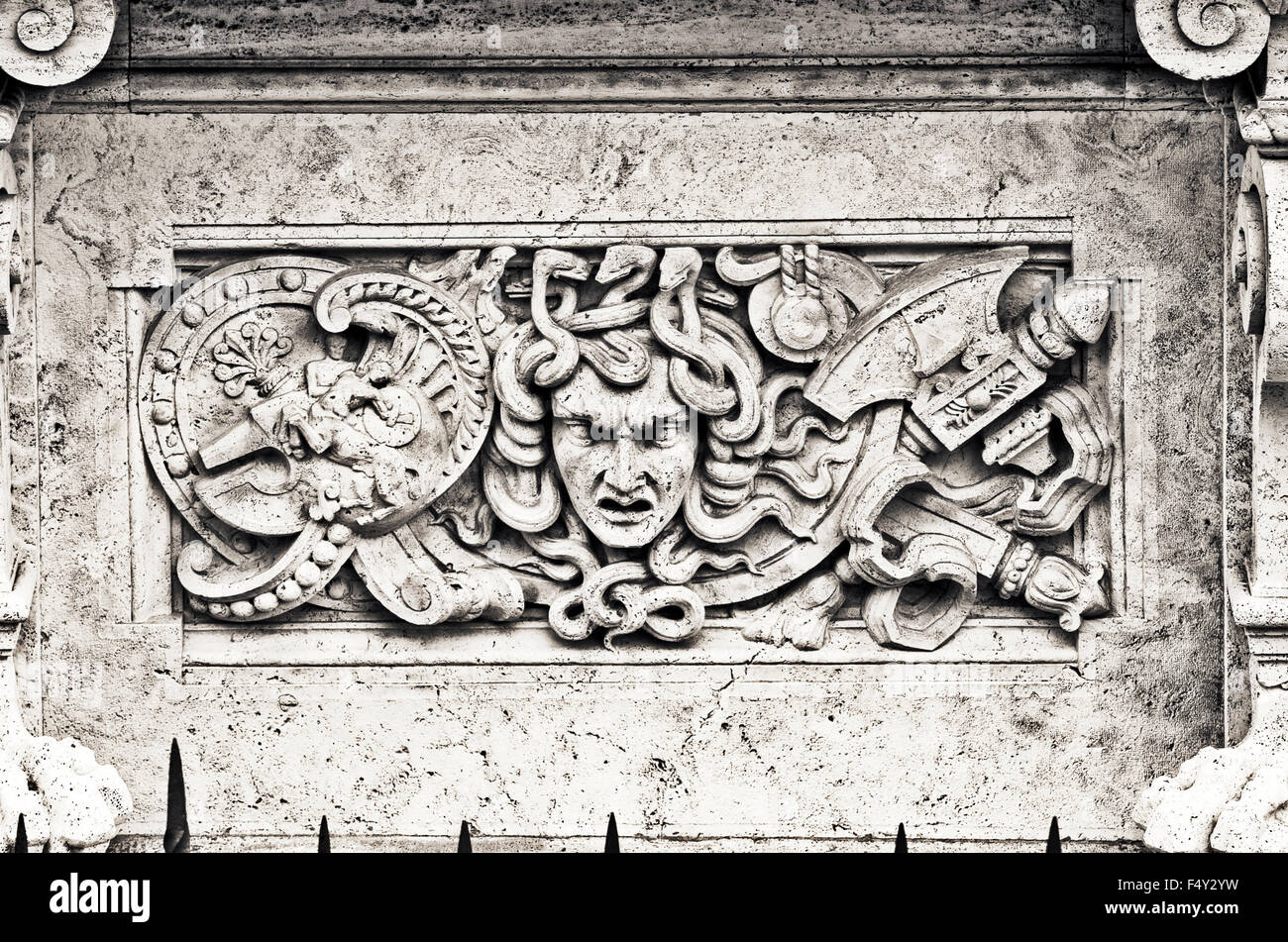 Bas-relief with Medusa's head carved on the stone facade of an art deco ...