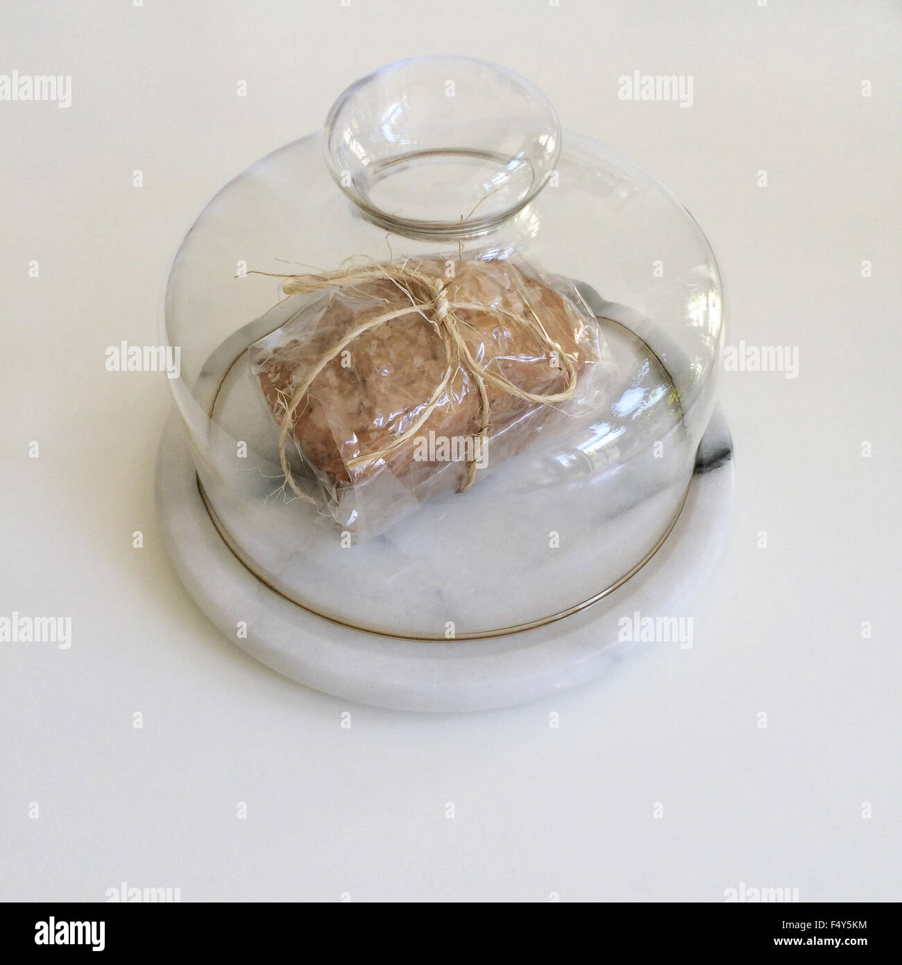 Individually wrapped bread under a cake bell Stock Photo - Alamy