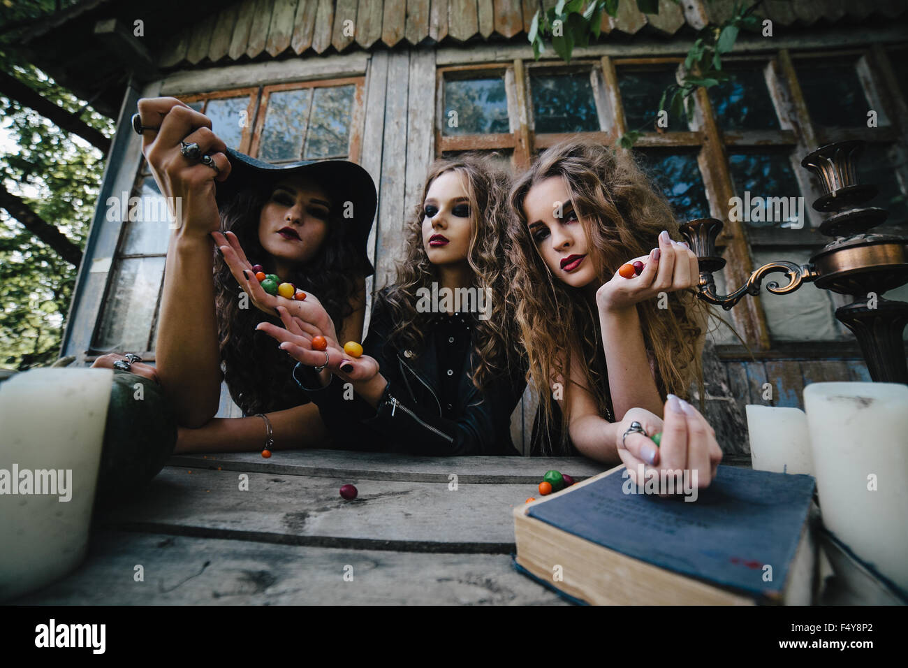Three vintage witches perform magic ritual Stock Photo - Alamy