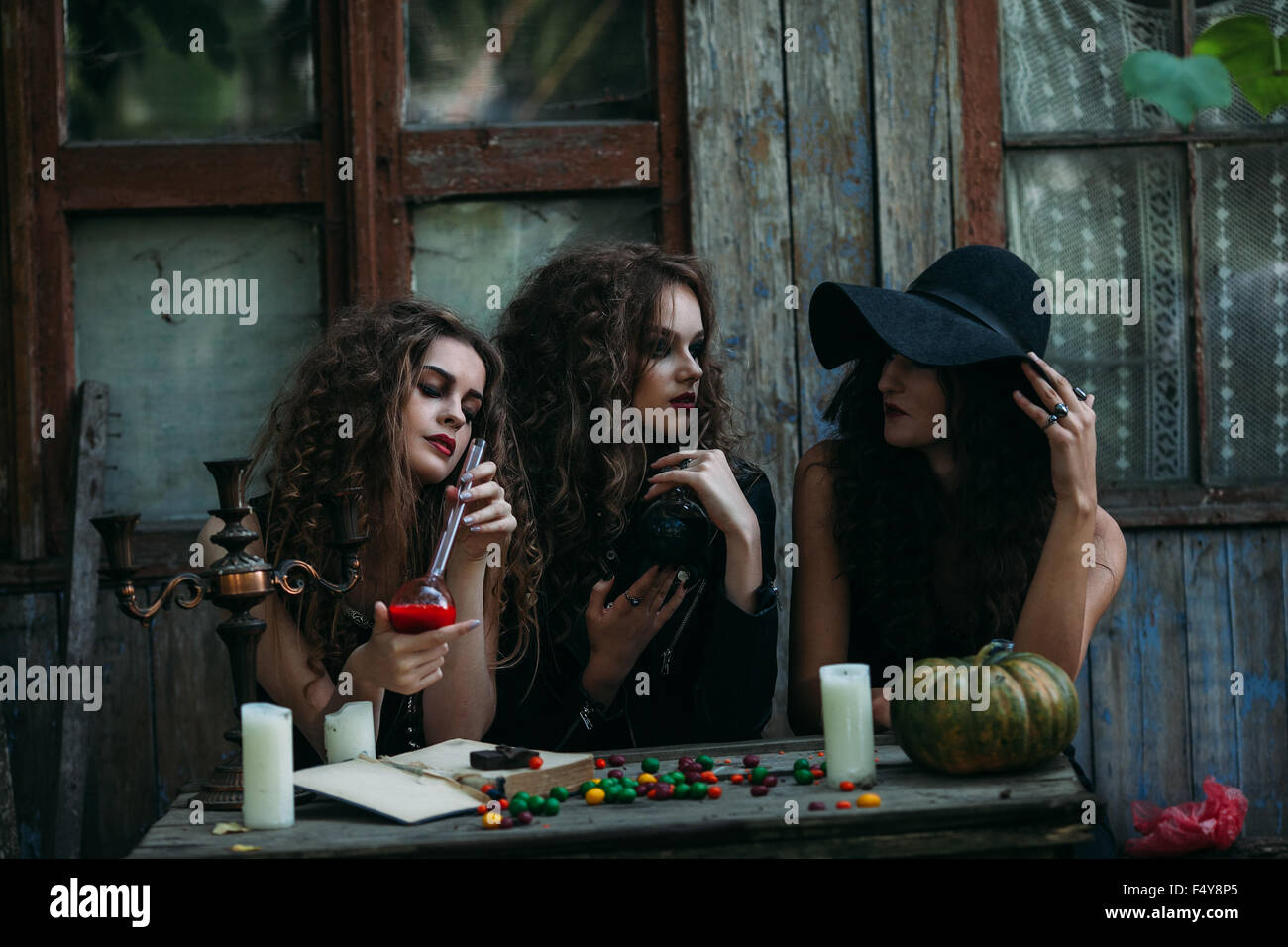 Three vintage witches perform magic ritual Stock Photo - Alamy