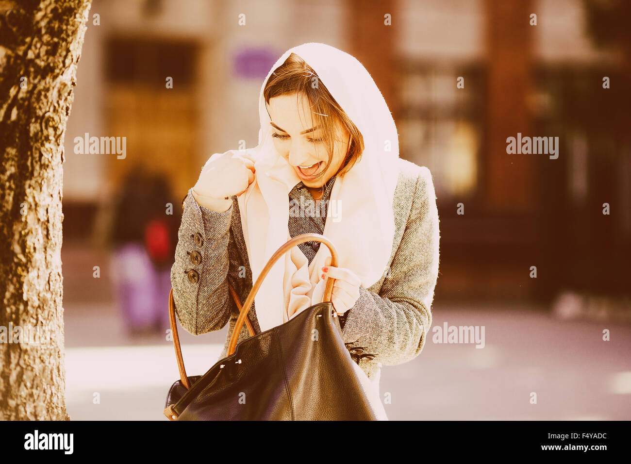 girl looking for something in a bag Stock Photo - Alamy