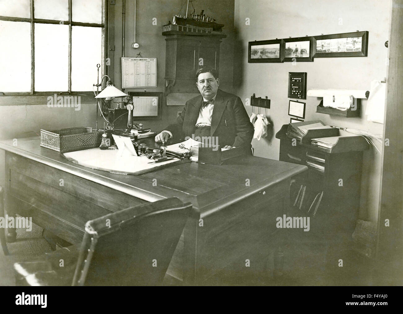 An employee at his desk, Italy Stock Photo - Alamy