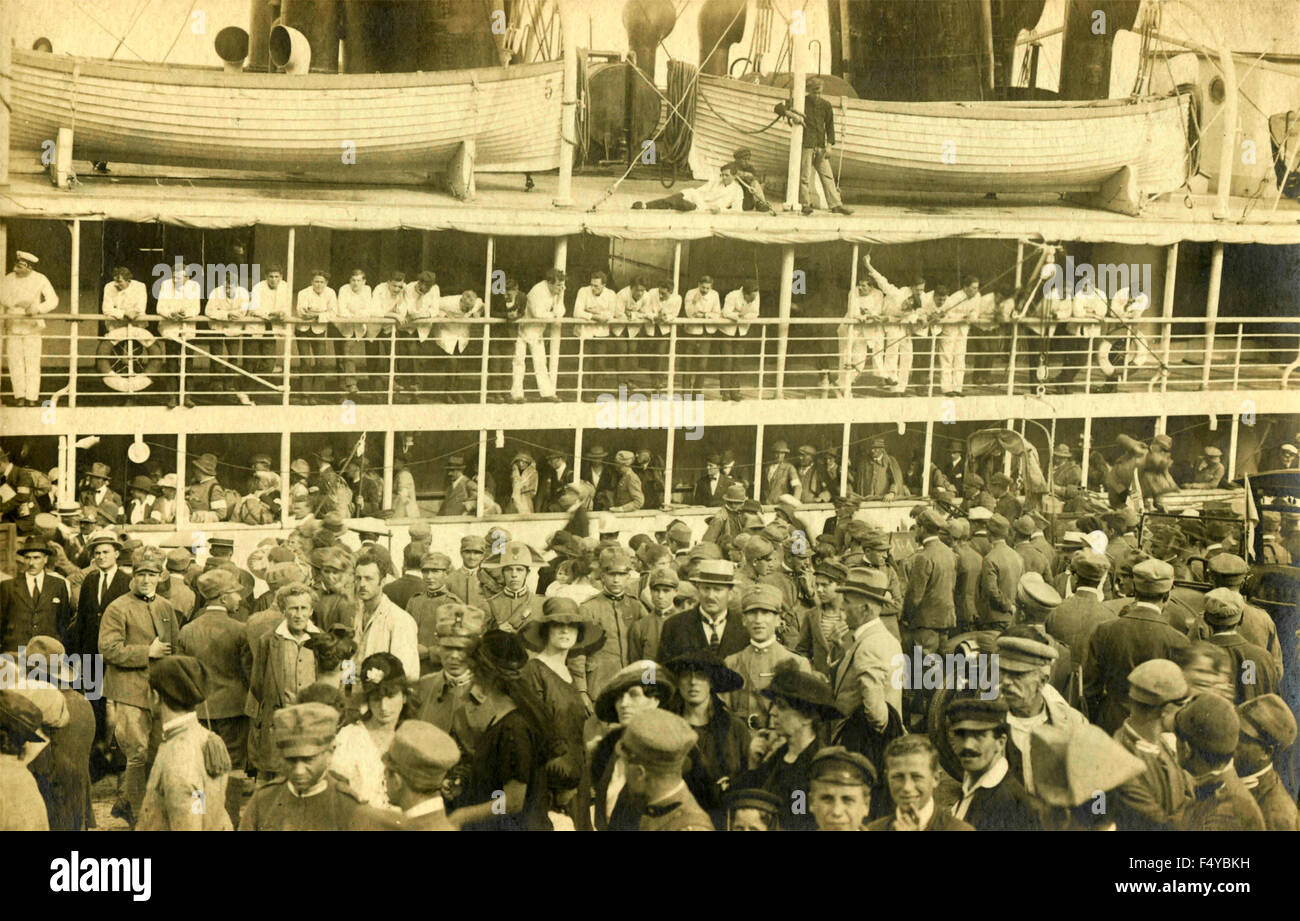 A ship in port with a crowd of people around, Italy Stock Photo - Alamy