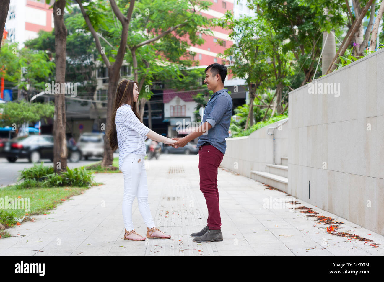 Asian couple hold hands happy smile looking to face dating Stock Photo ...