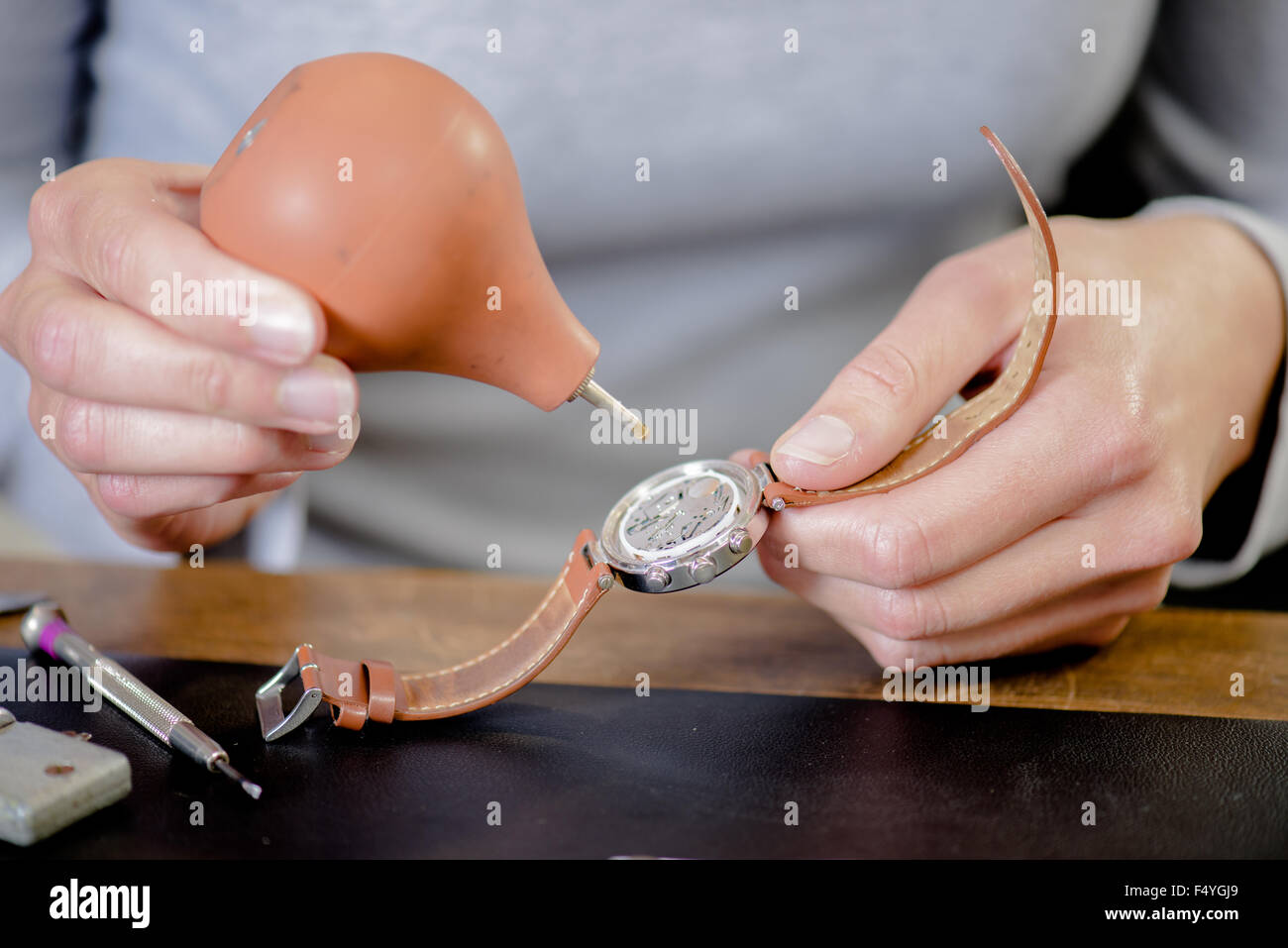 Female watch repair expert Stock Photo - Alamy