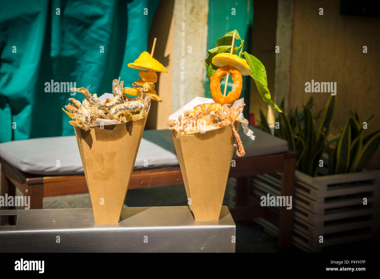 Traditional Italian snack street food - fried calamari rings, anchovy ...