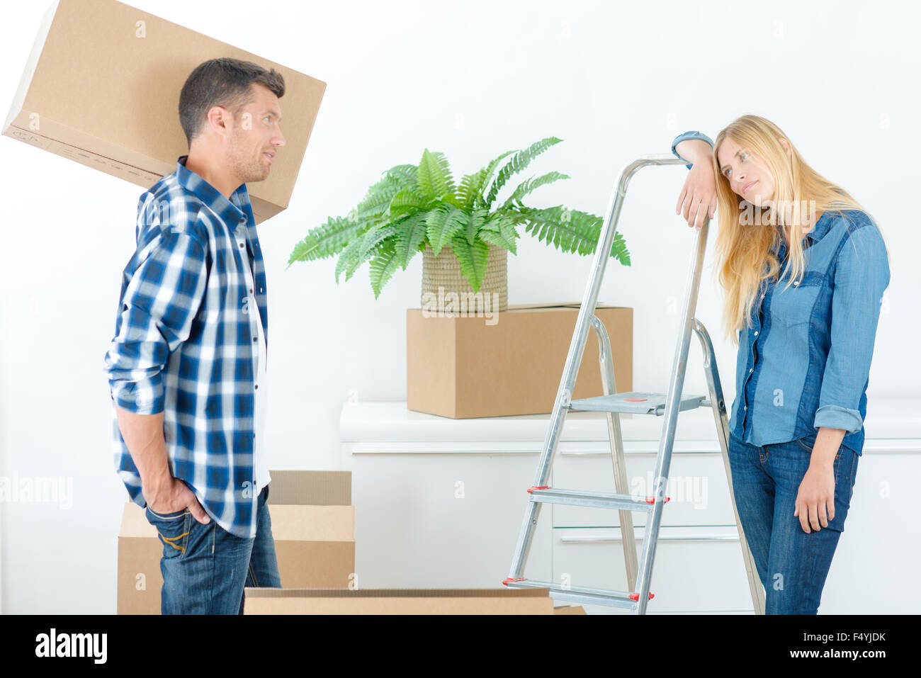 Couple feeling tired after moving house Stock Photo - Alamy