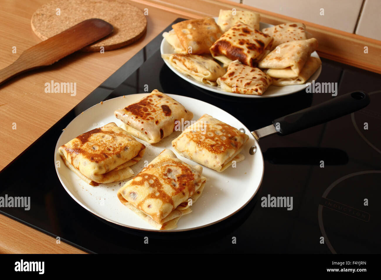 Frying pancakes with fillings. Traditional russian pancakes (blini ...
