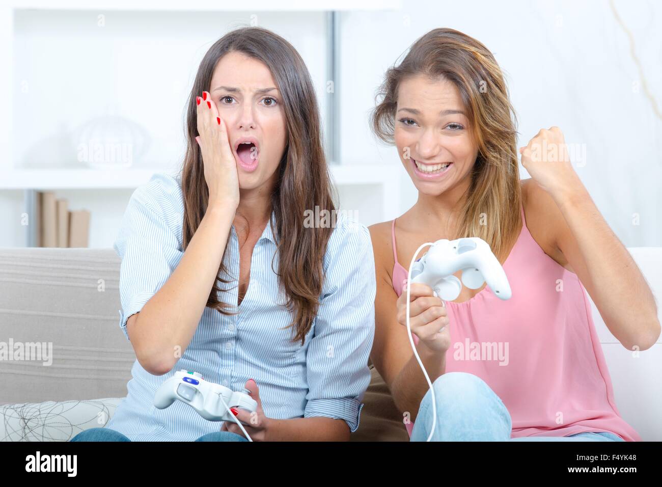 Two girls playing computer game Stock Photo - Alamy