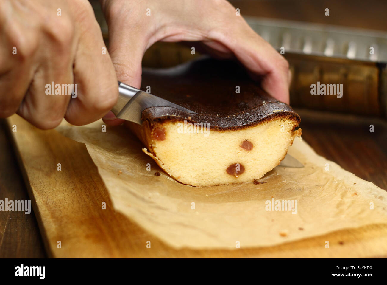 Man slicing curd pudding Stock Photo - Alamy