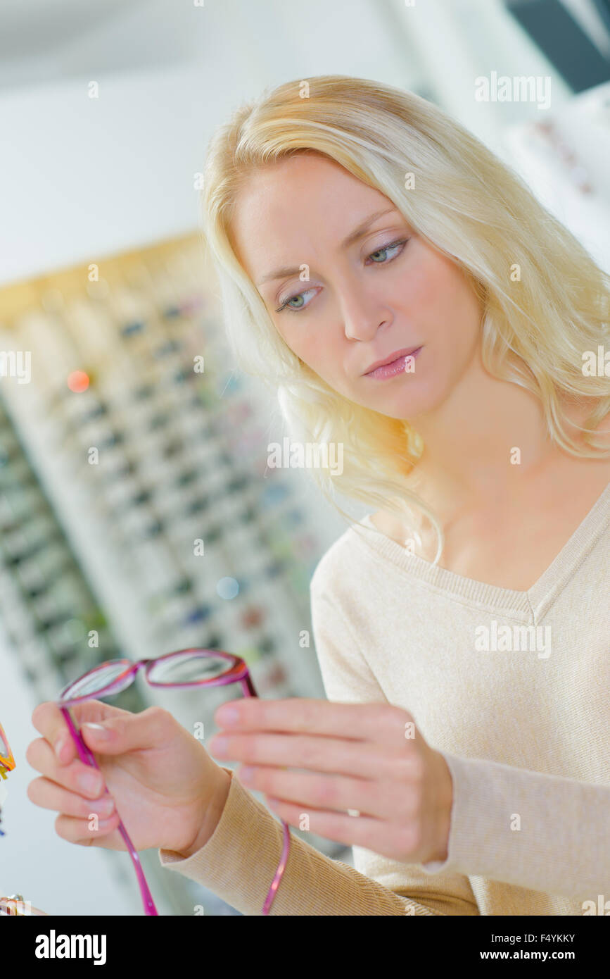Choosing frames at the opticians Stock Photo - Alamy