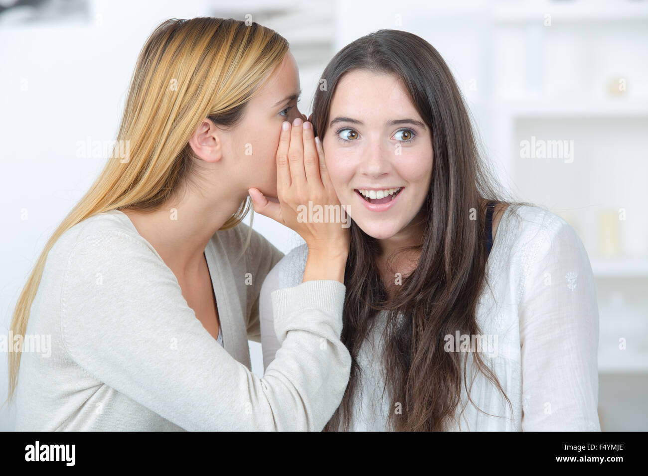 Whispering a secret Stock Photo - Alamy