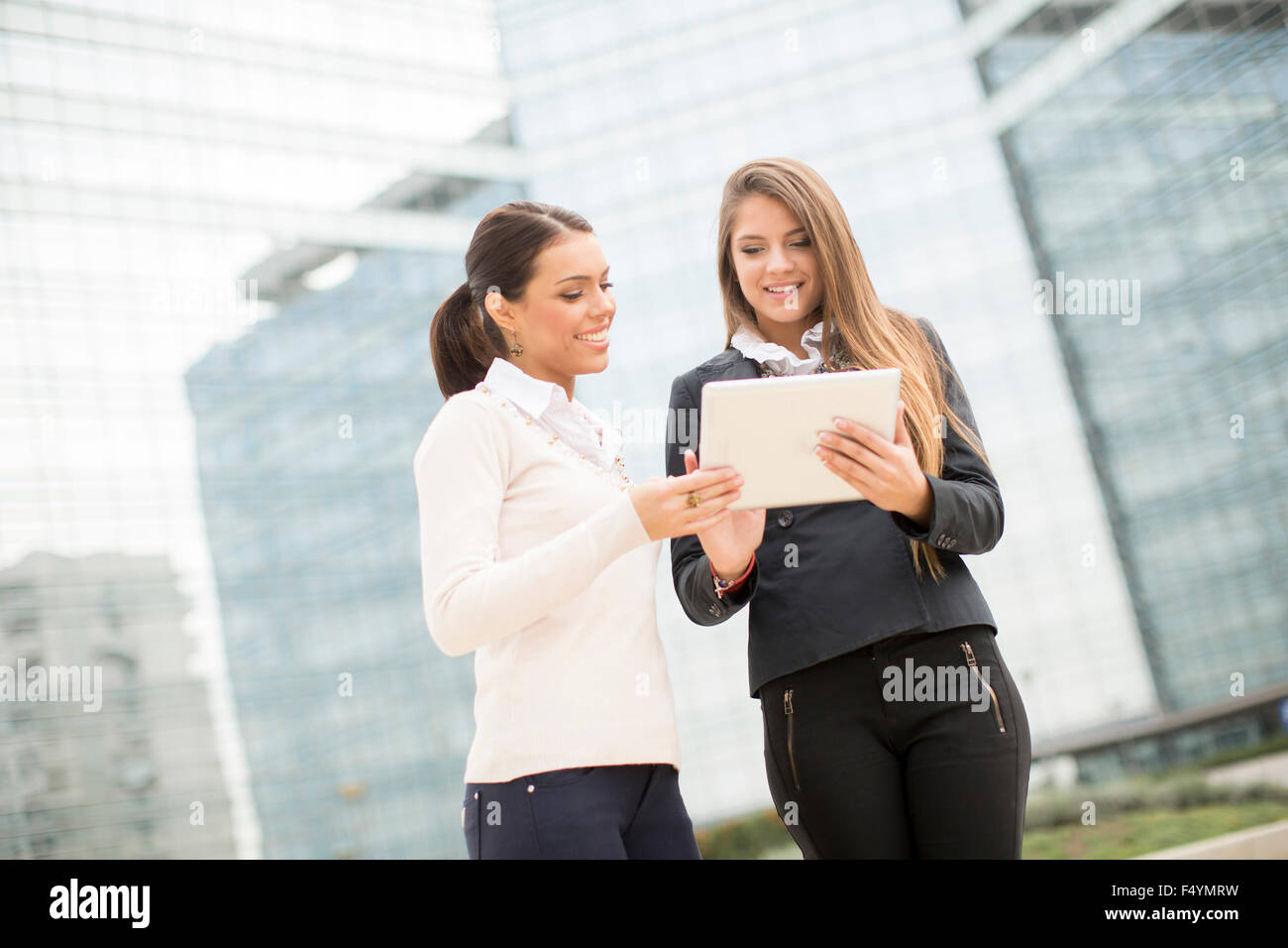 Young business women in front of office building Stock Photo - Alamy