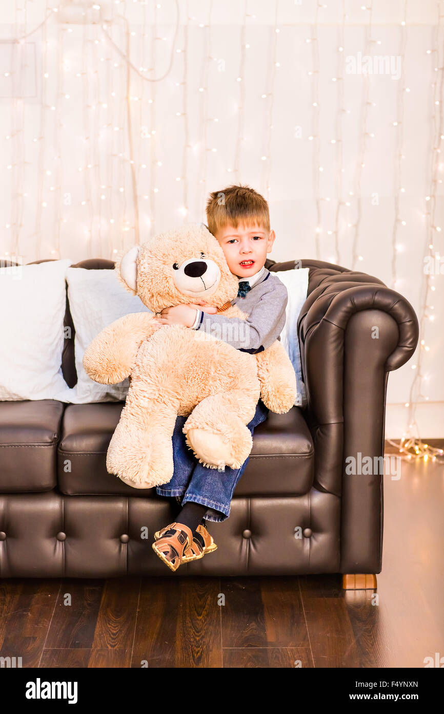 Portrait of little boy with teddy bear at home Stock Photo - Alamy
