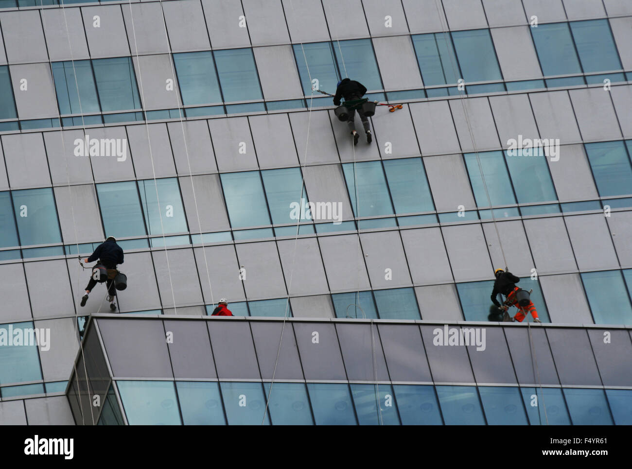 Workers are cleaning windows outside office building Stock Photo - Alamy