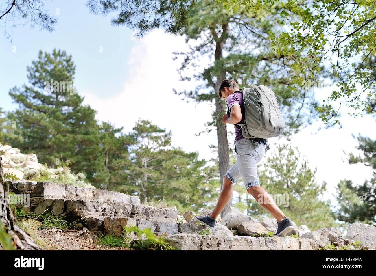 hiker with backpack doing trekking on a mountain path Stock Photo - Alamy