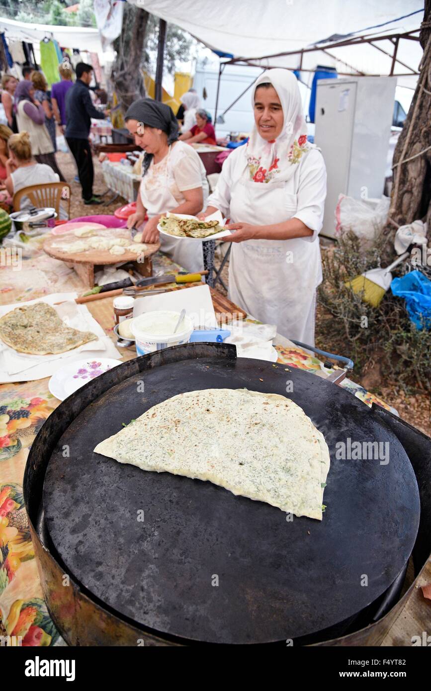 KAS Antalya Turkey Friday Market making traditional pancakes on a cast ...