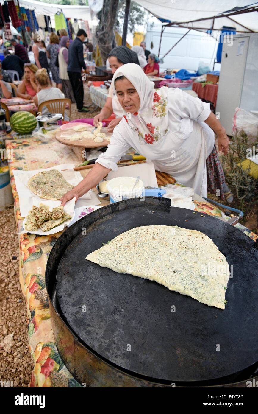 KAS Antalya Turkey Friday Market making traditional pancakes on a cast ...