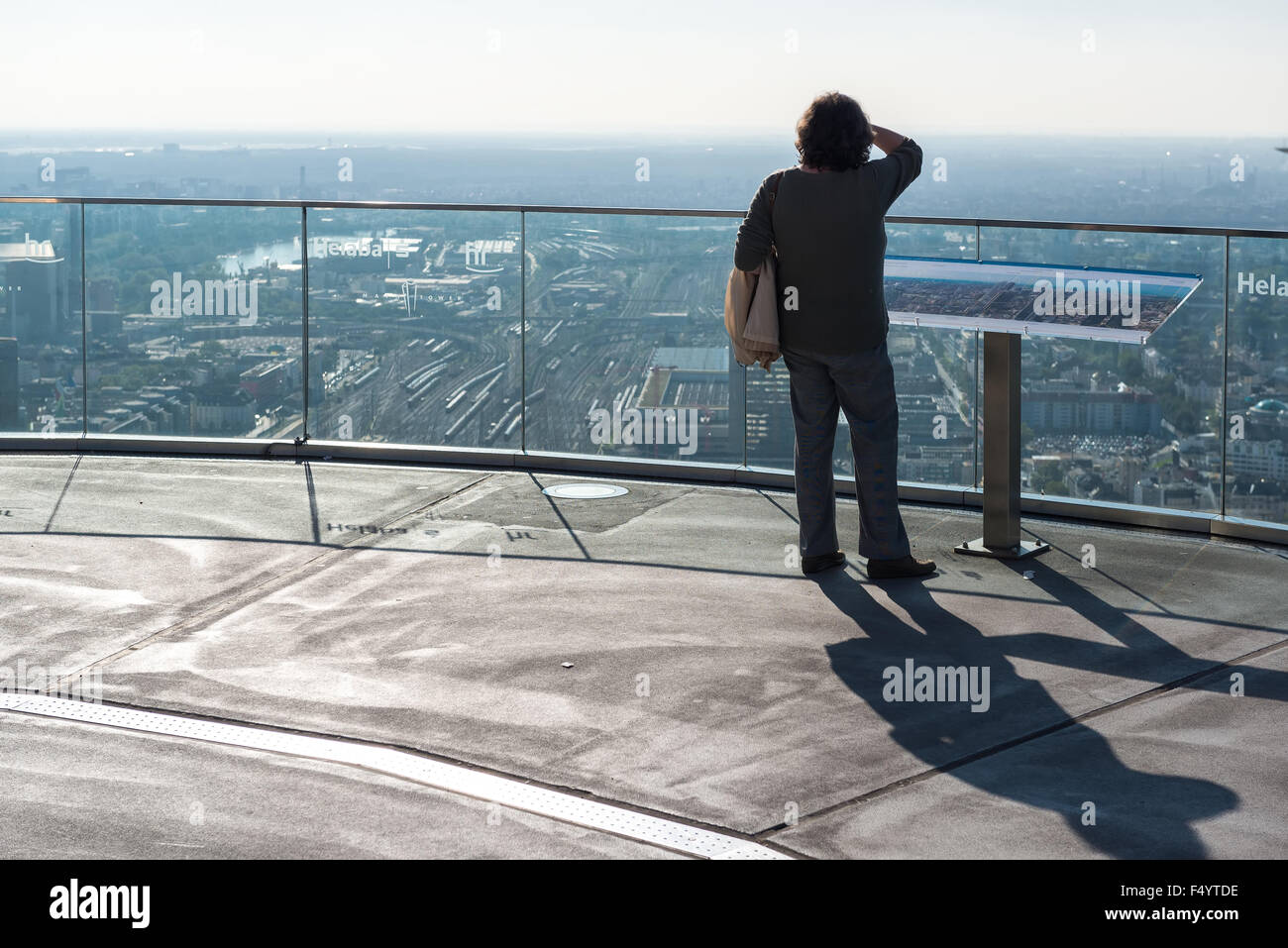 Visitor standing on the Main Tower observation deck in the Frankfurt am ...