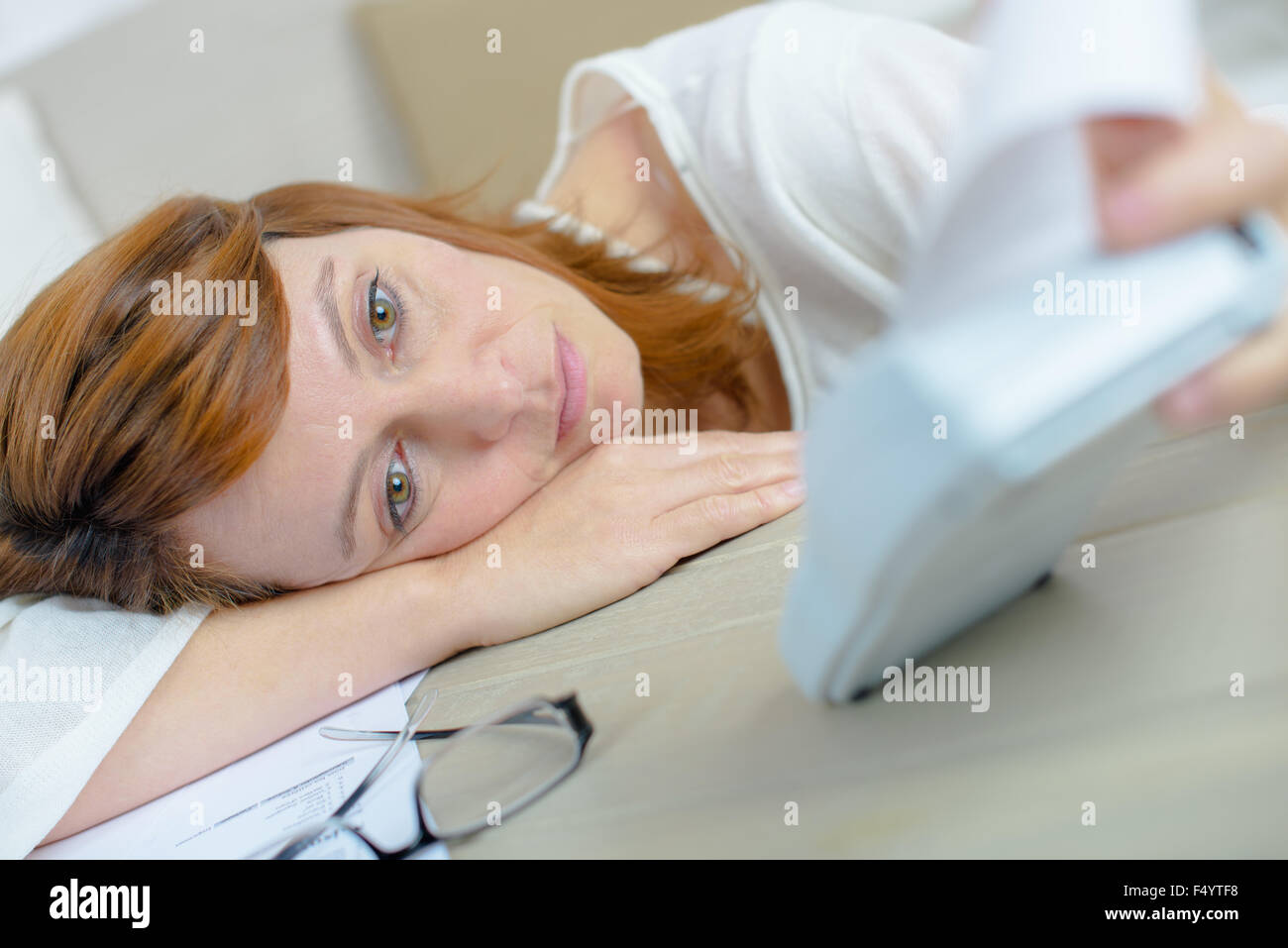 Sad lady slouched on table Stock Photo - Alamy