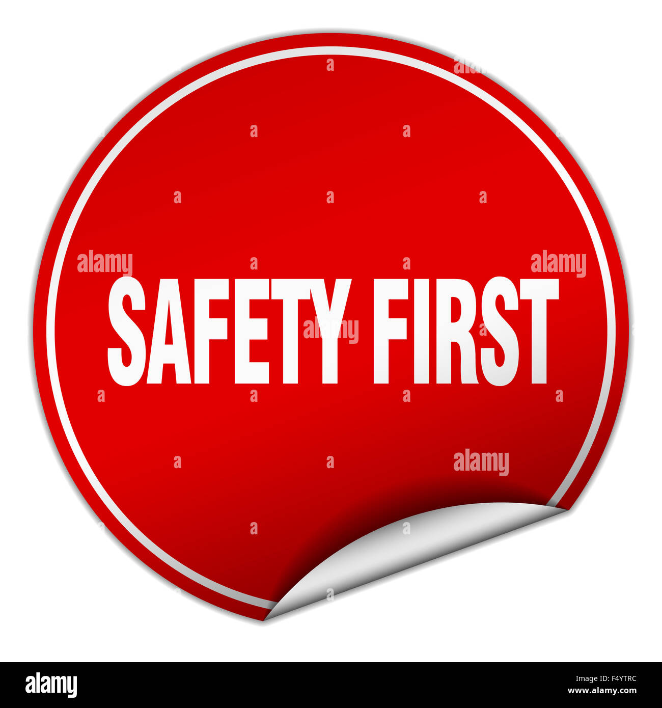 safety first round red sticker isolated on white Stock Photo - Alamy