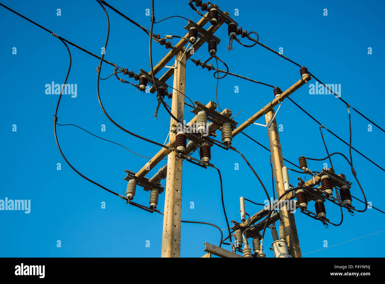 Electricity post and a blue sky background Stock Photo - Alamy