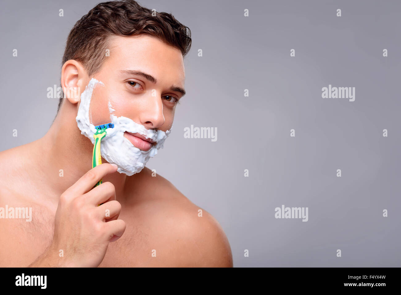 Pleasant guy shaving Stock Photo - Alamy