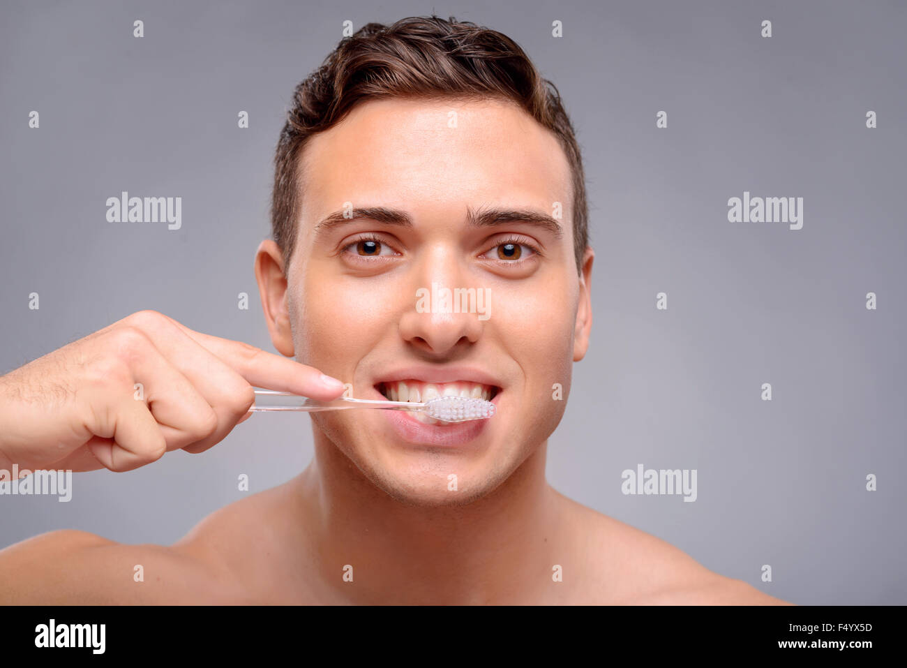 Handsome man cleaning teeth Stock Photo - Alamy