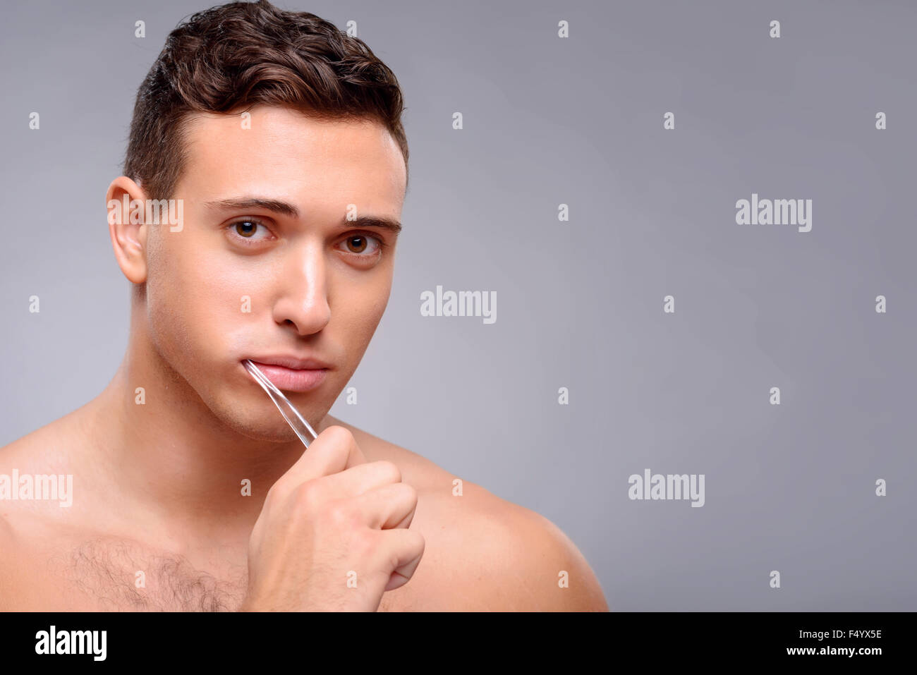 Handsome man cleaning teeth Stock Photo - Alamy
