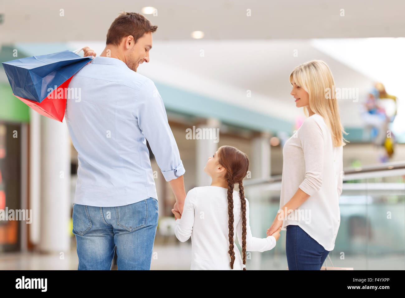 Friendly family walking around shopping mall Stock Photo - Alamy
