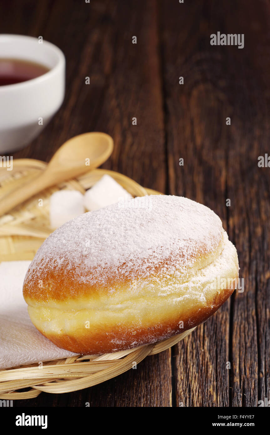 Berliner donut with cup of hot coffee on dark wooden table Stock Photo ...