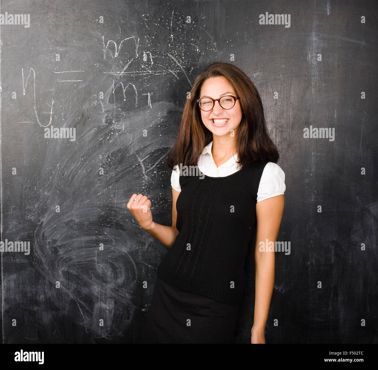 portrait of happy cute student at blackboard in classroom smiling Stock ...