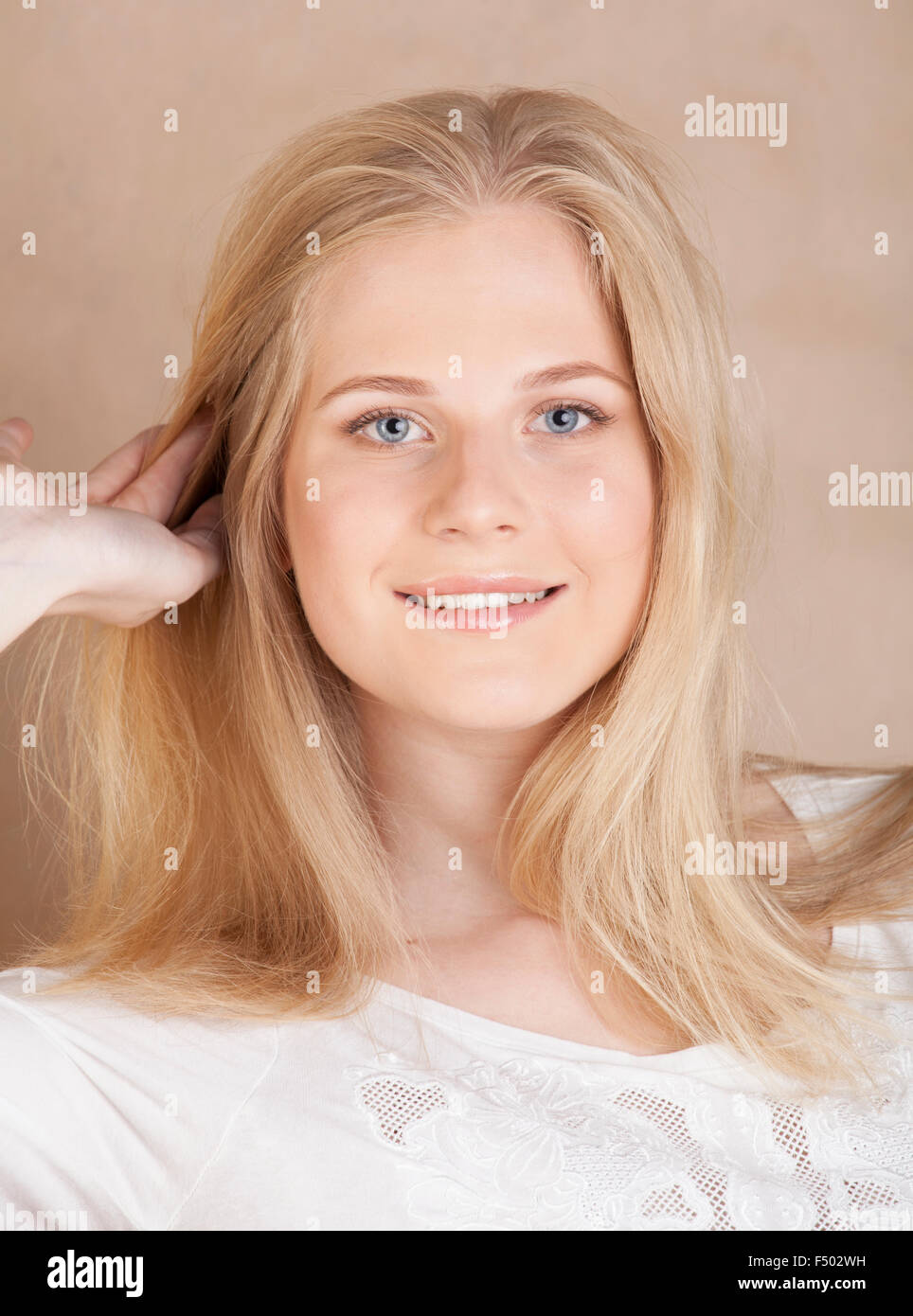 young cool blong teenage girl messed with her hair smiling Stock Photo ...
