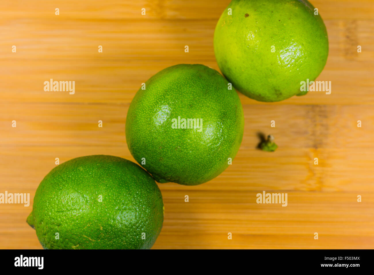 Close up tropic fruits lime on the wood table Stock Photo - Alamy