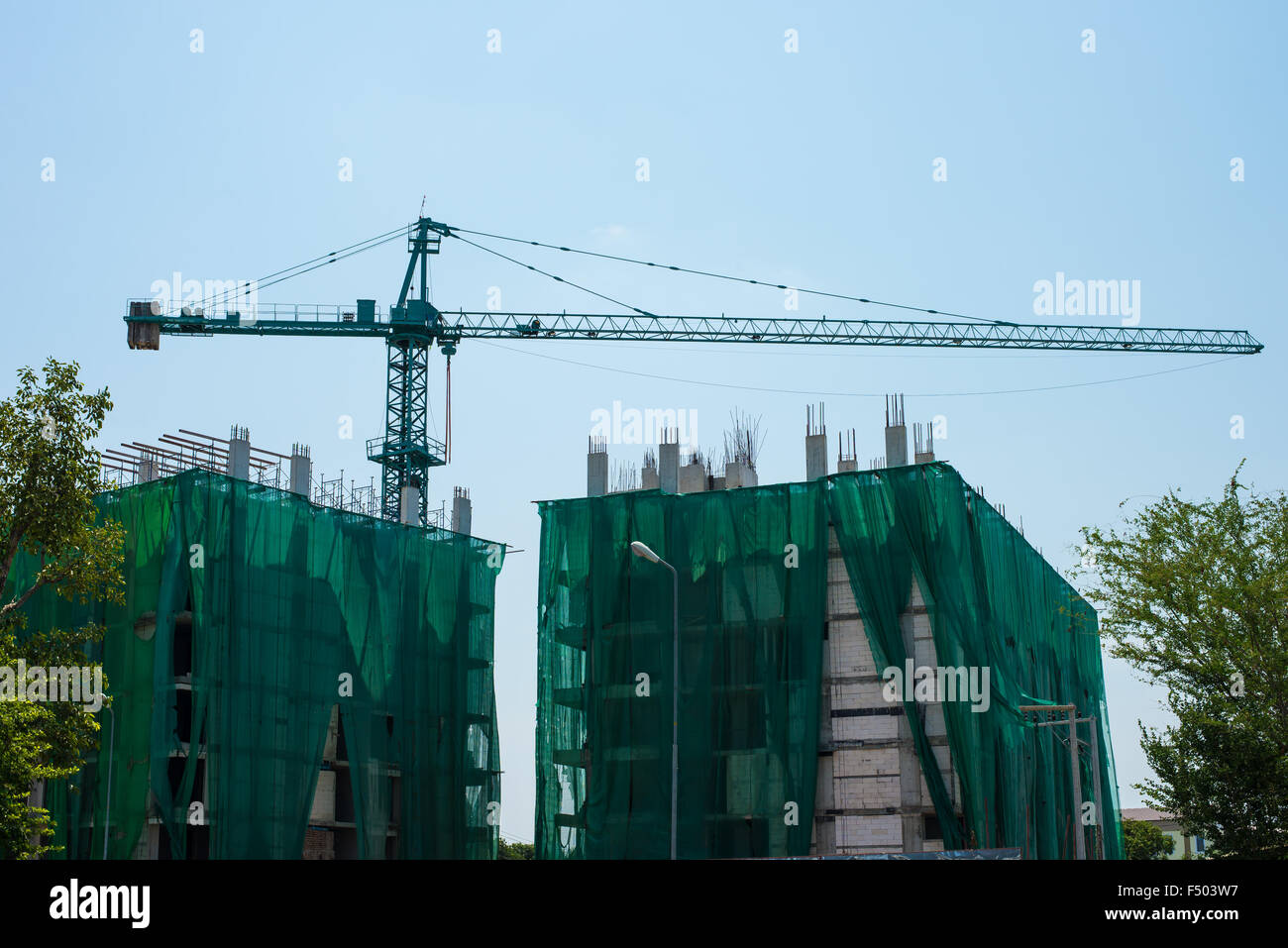 Derrick is used in the construction of tall buildings Stock Photo - Alamy