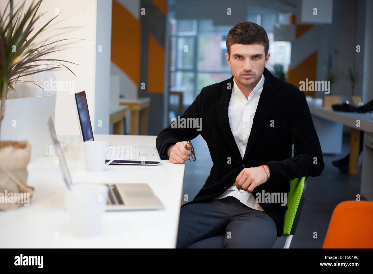 Employee posing on workplace Stock Photo - Alamy