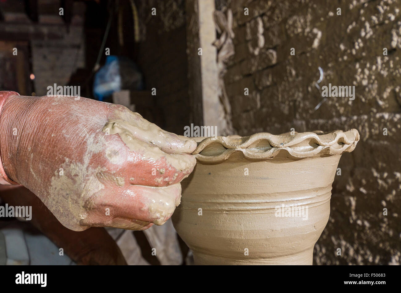 Man making pottery by hand with simple equipment Stock Photo - Alamy