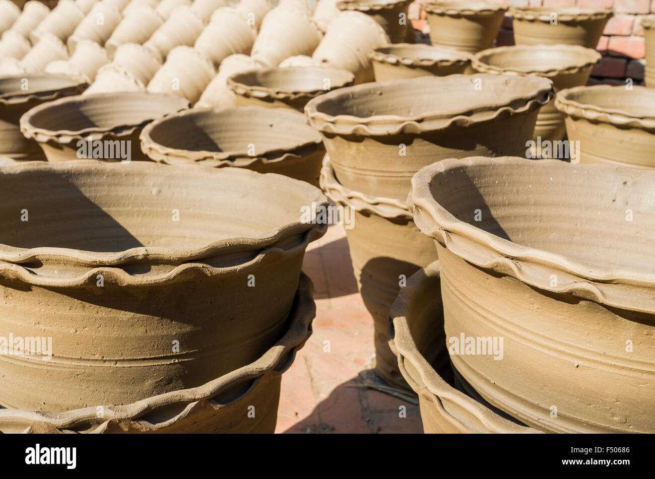 Newly made pottery is drying in the sun before getting burned Stock ...