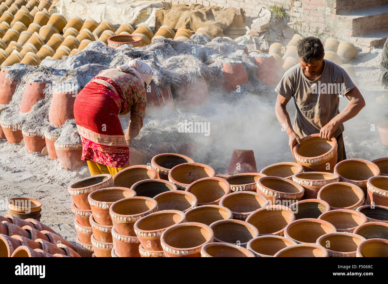 Workers sorting out pottery after the burning process Stock Photo - Alamy