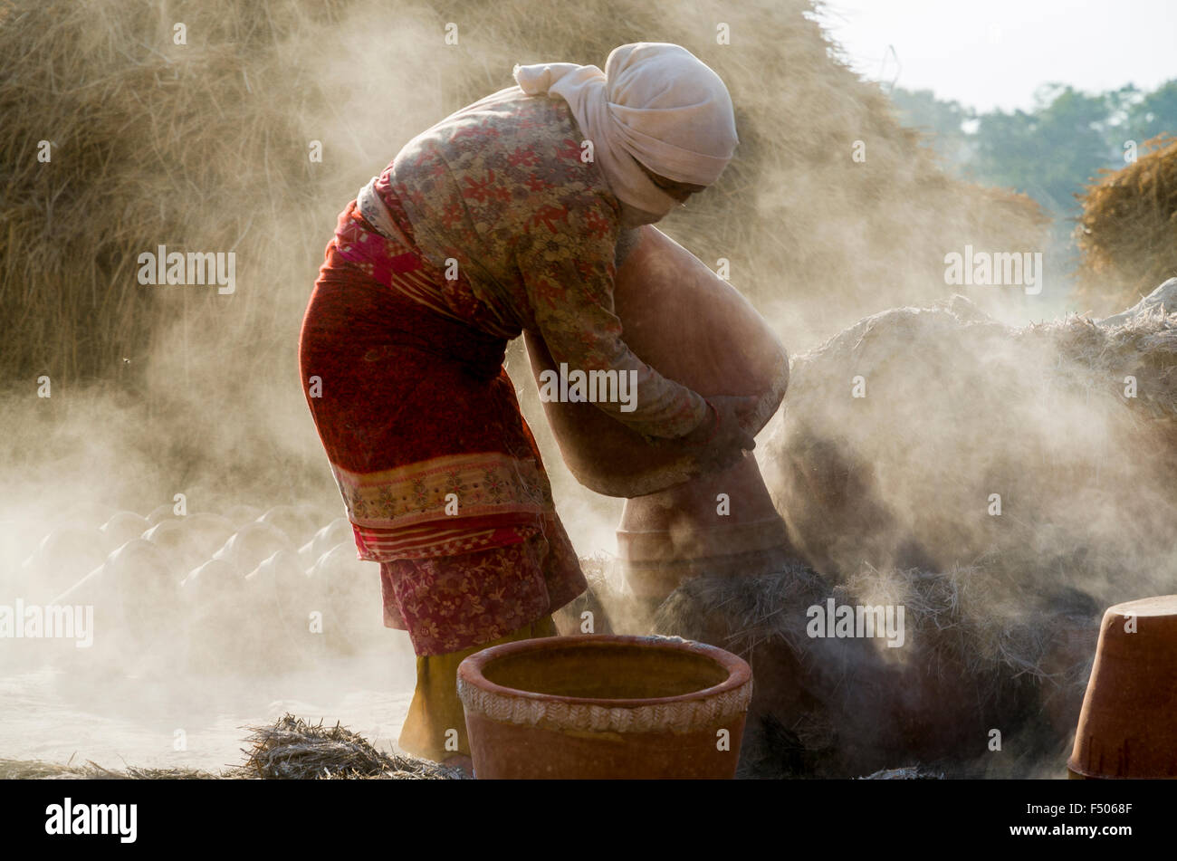 Worker sorting out pottery after the burning process Stock Photo - Alamy