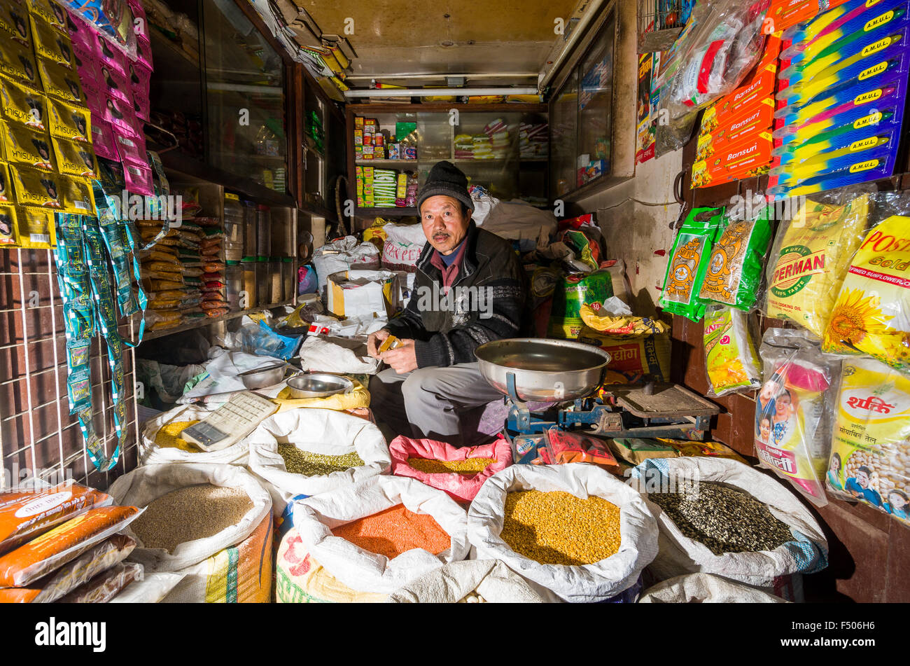 Man selling many different food items in his shop Stock Photo - Alamy
