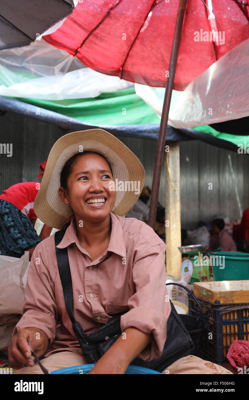 Female Asian merchand in her selling area on a market in Sisophon ...