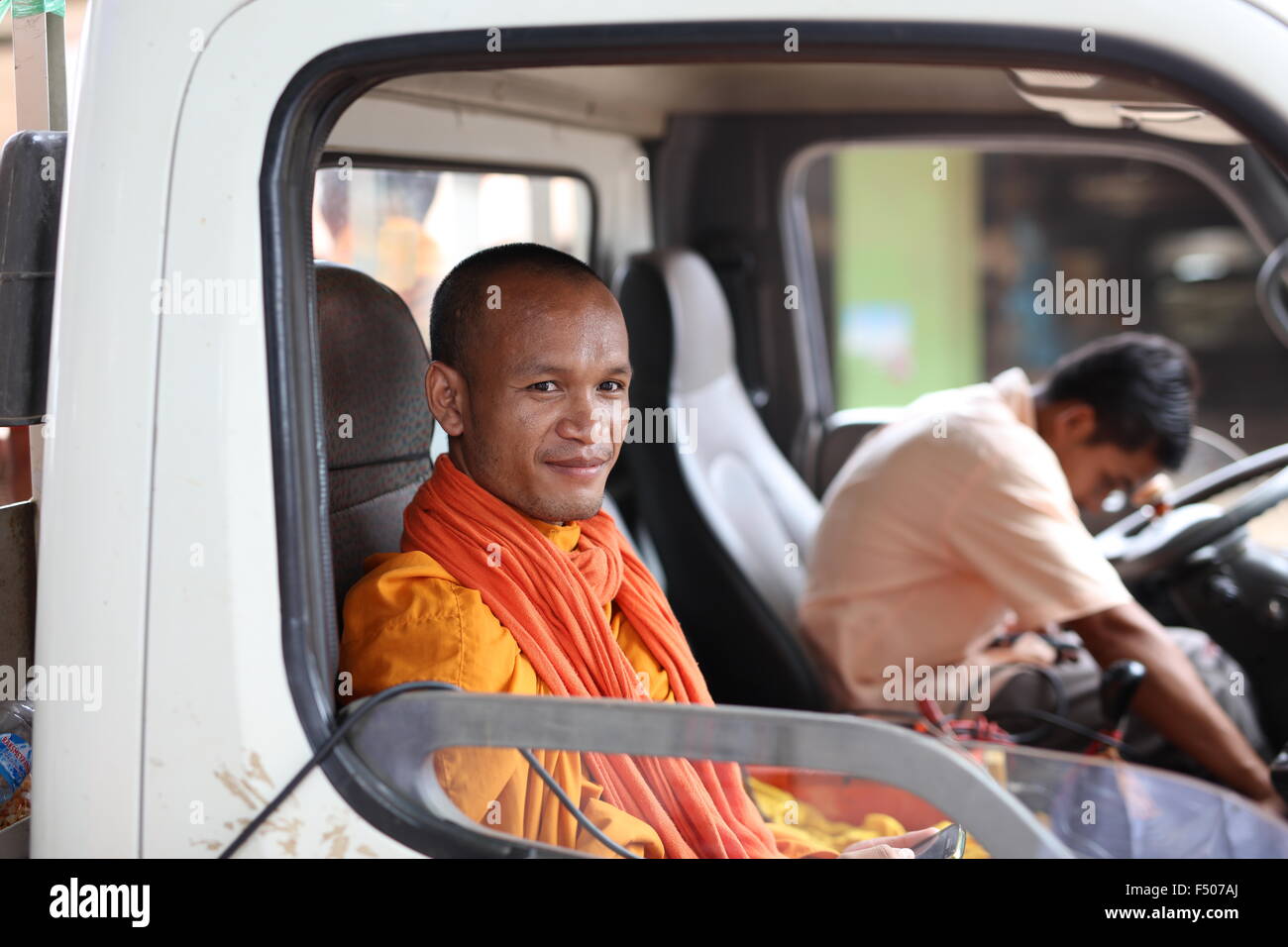Monk on passenger side of left hand driven truck in Cambodia with with ...