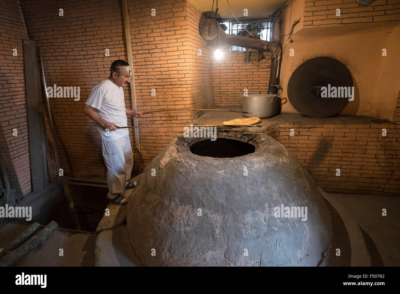 General view of a baker in Tbilisi, Georgia making fresh bread from a ...