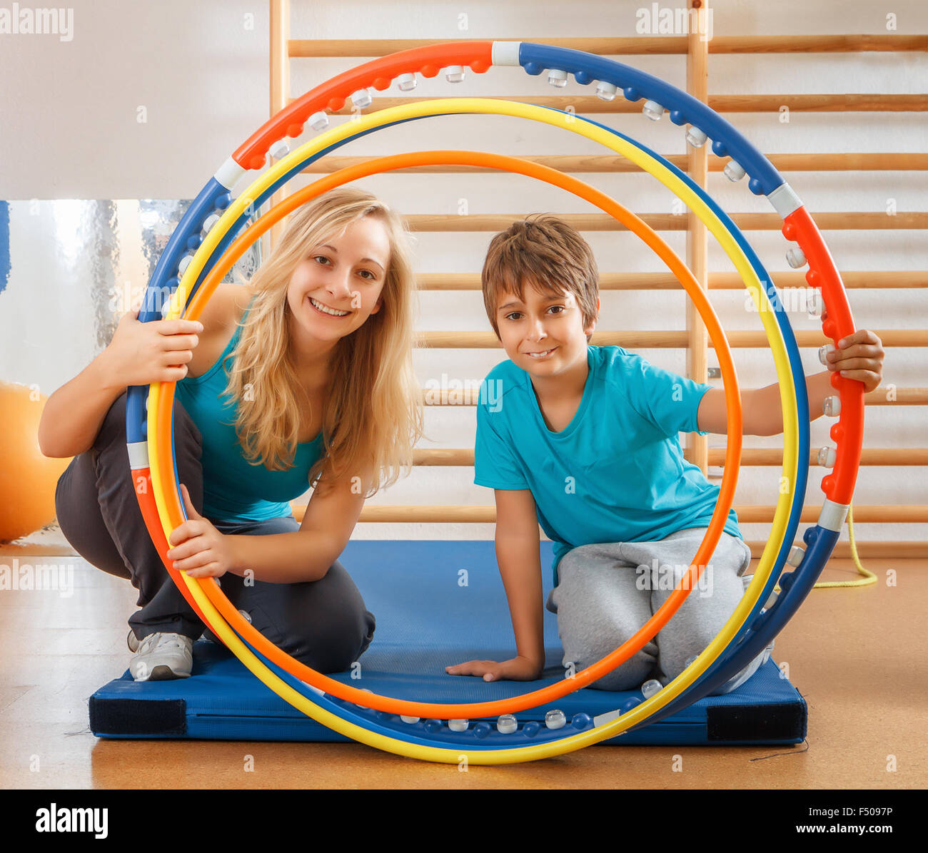 Happy, sports family, mother and son looking through hula hoops Stock ...